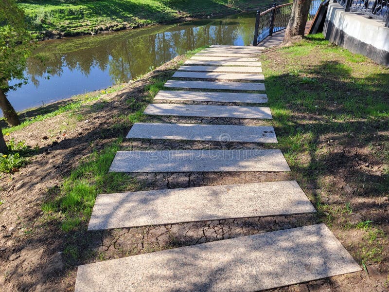 A Path of Concrete Rectangles is Laid Along a Shady Spring Lawn Along ...