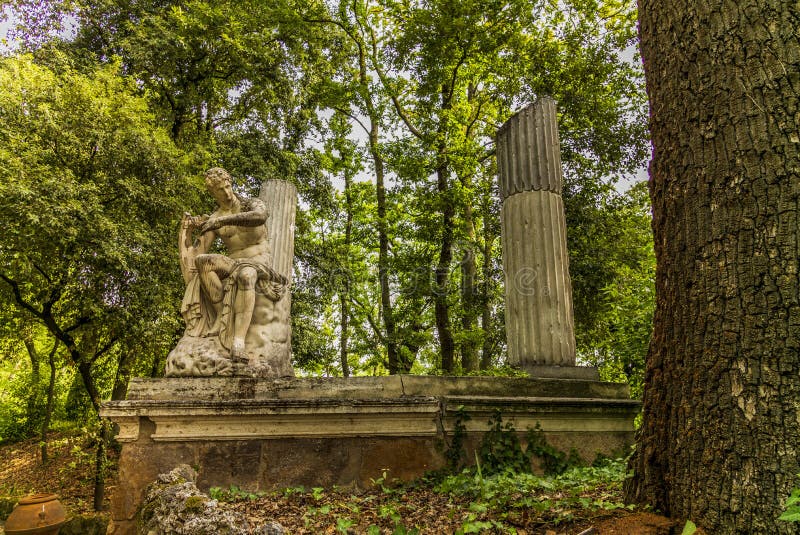 A Path in a Garden in Rome with Old Statues, Columns, and Water ...