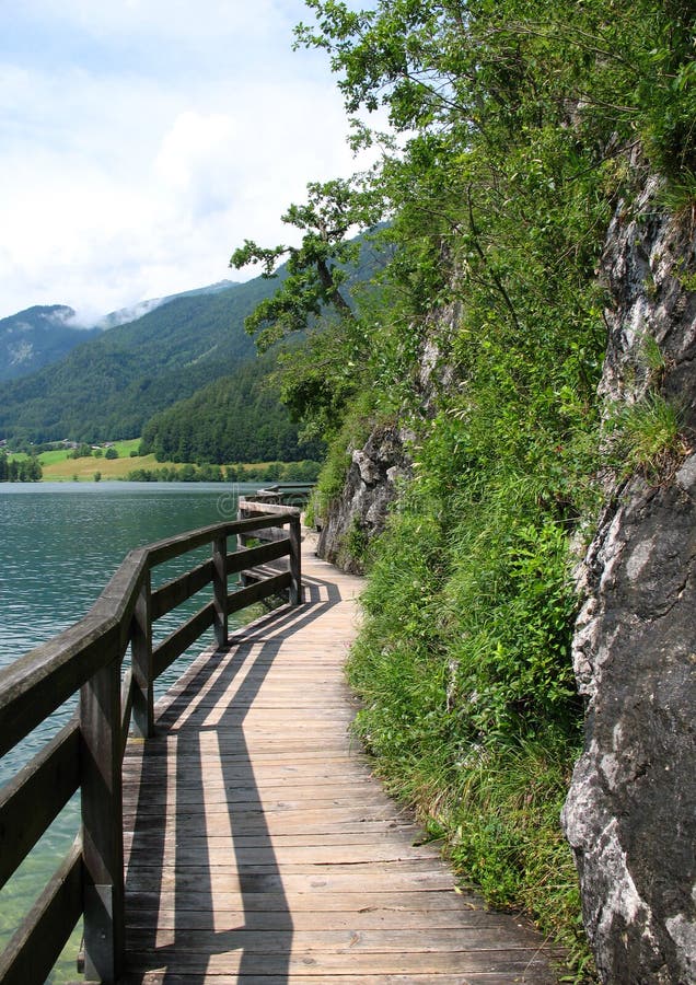 Path between lake and rock stock image. Image of relaxation - 10199499
