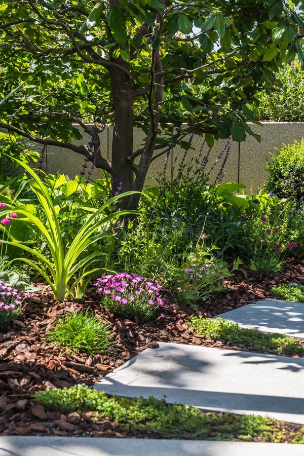 Path with Large Stone Slabs through a Beautifully Planted Garden Stock ...