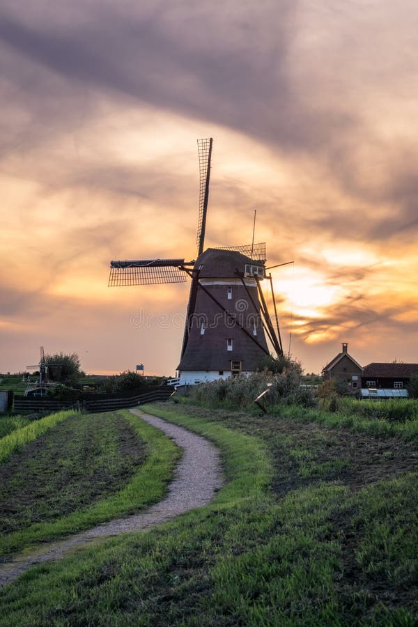Path Leading To a Windmill at Sunset Stock Photo - Image of evening ...