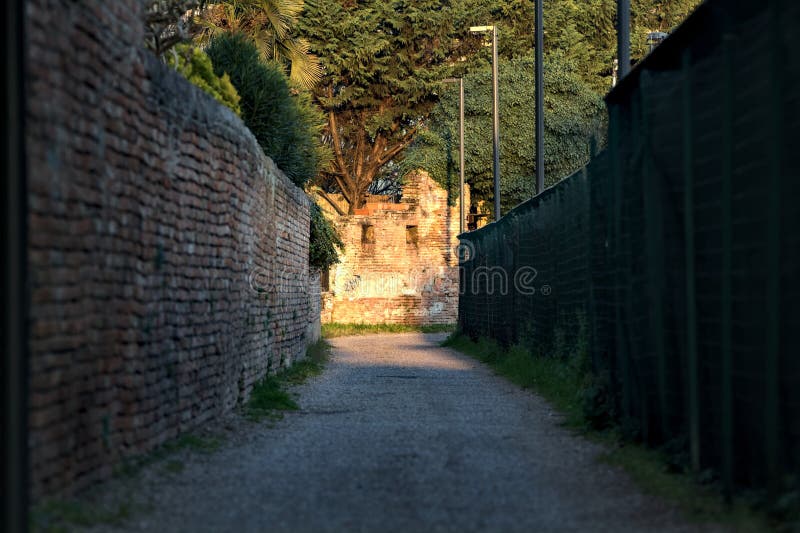 Path Next To a Brick Wall at Sunset Stock Image - Image of brick ...