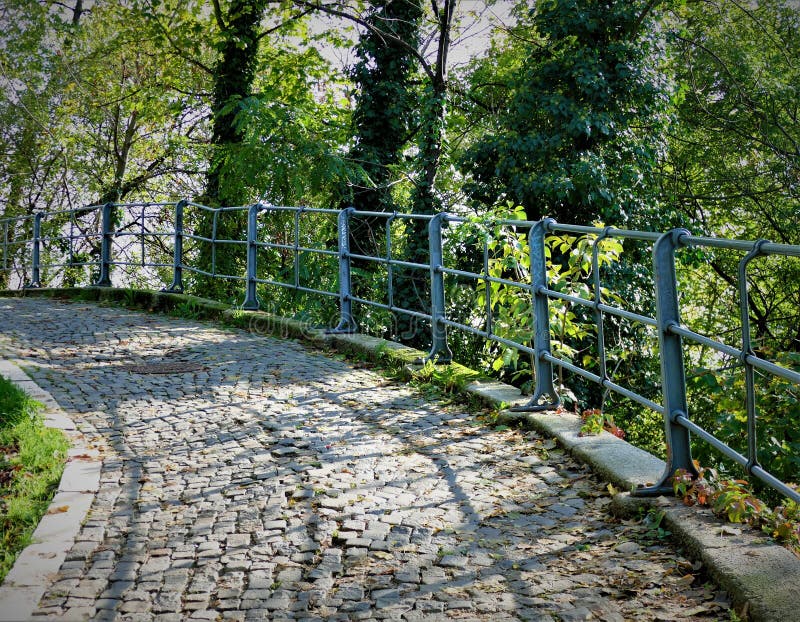 Path in the Park and Metal Fence Stock Photo - Image of sidewalk ...