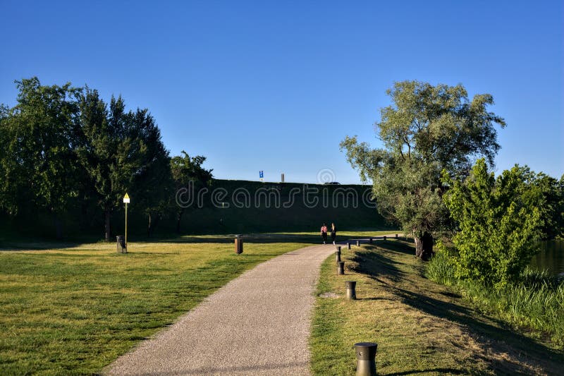 Path with People Walking by the Shore of a Lake on a Clear Day ...