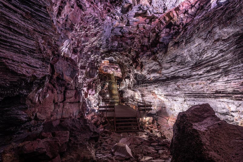 A Path and a Staircase through Purple Illuminated Rock Structures in ...