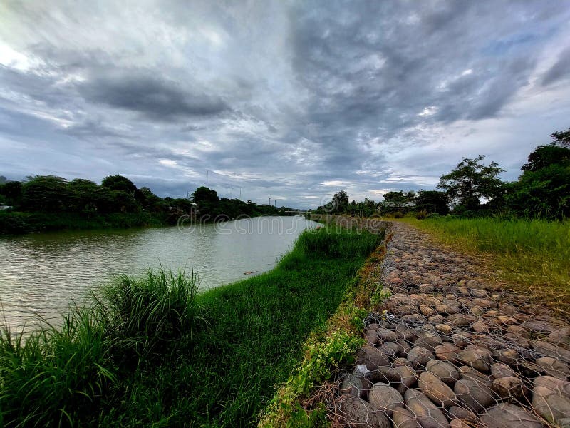 A path way on a calm river stock image. Image of cloud - 215390229