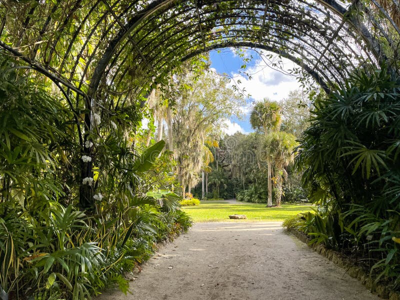 A Pathrway Surrounded by an Arch Trellis that Opens into a Botanical ...