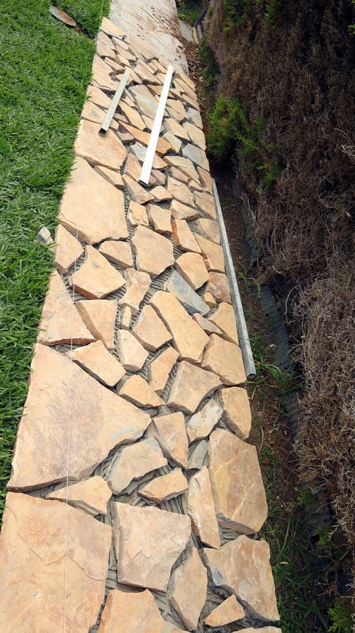 Pathway is Being Constructed with Uneven, Natural Stone Tiles, Placed ...