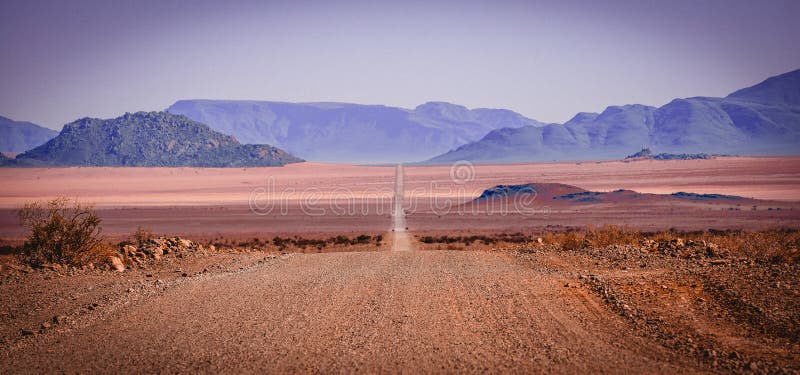 A Pathway in a Desert Area Surrounded by Breathtaking Mountains Under ...