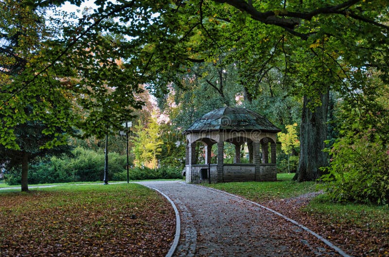 Pathway with Pavilion and Flower Bed in Foreground Surrounded by ...
