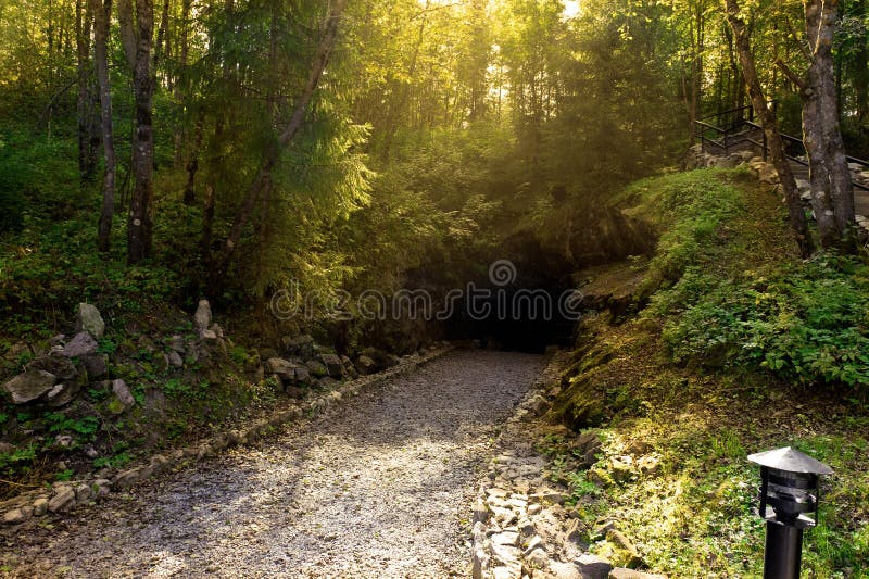 Pathway leading to a cave stock image. Image of blue - 53589643