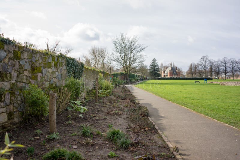 Pathway in a Park Along Side is a Wall and Border Stock Photo - Image ...