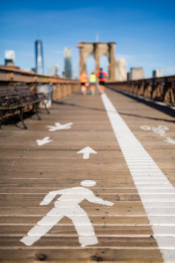 Pathway Sign on Brooklyn Bridge with Few Colorful Joggers Stock Photo ...