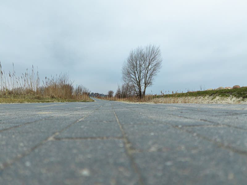 Pathway Stretches into the Distance beside a Barren Landscape Under ...