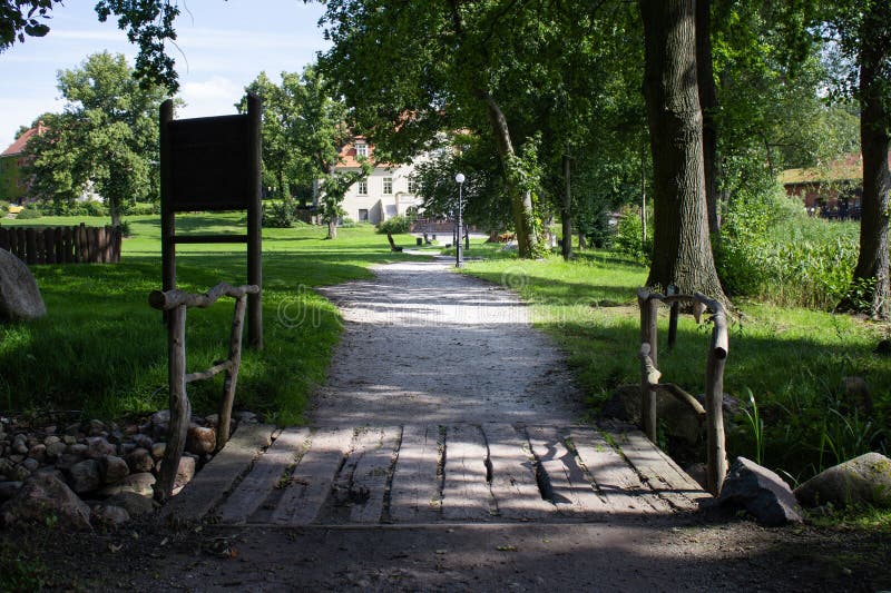 A Pathway through a Wooded Area with a Small Gate Across the Path Stock ...