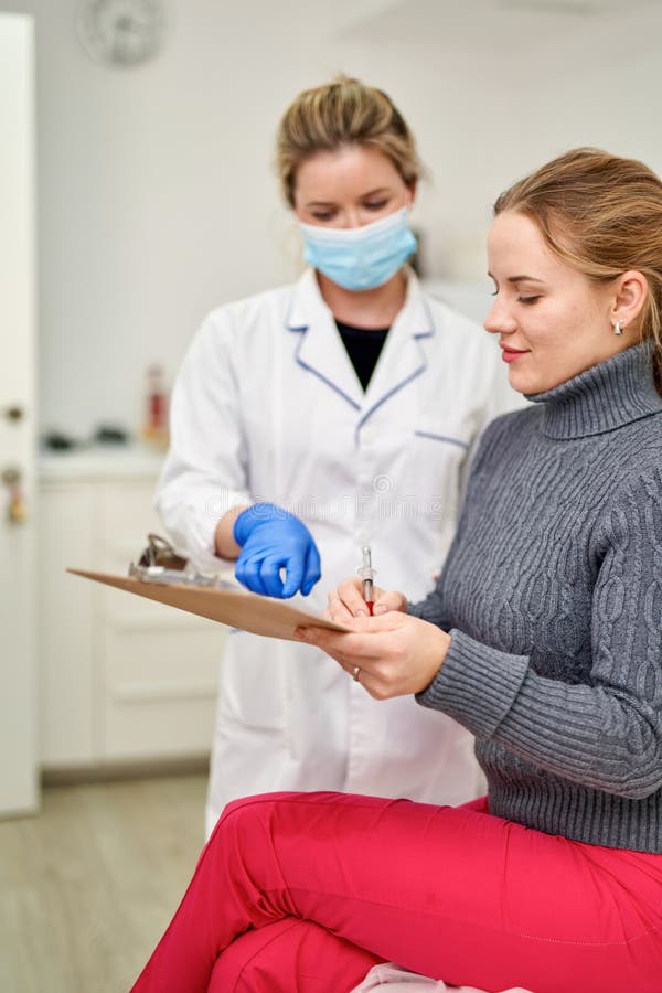 Patient in Aesthetics Clinic Signs Document Stock Photo - Image of ...
