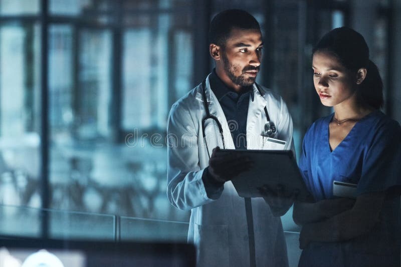 Patient Care is a 247 Commitment. Two Young Doctors Using a Digital ...