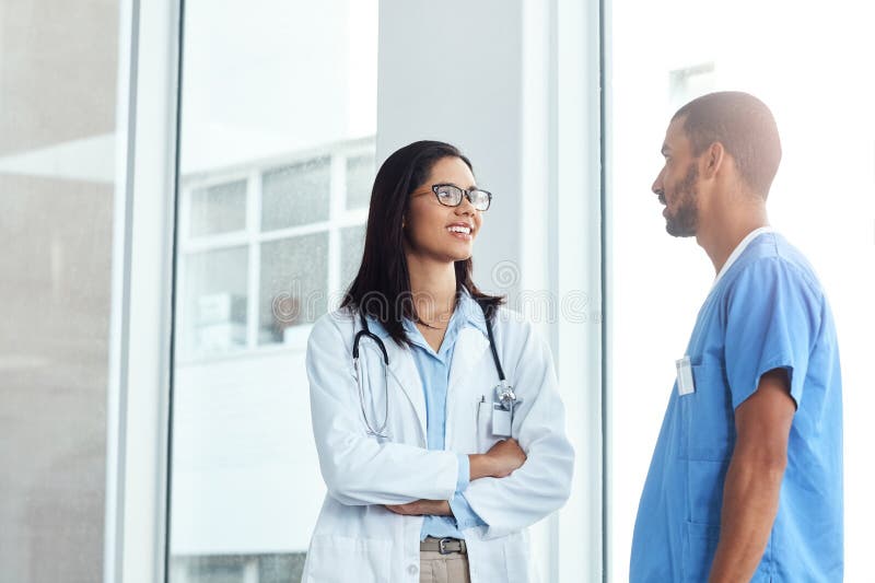 Patient Care is a Team Task. Two Young Doctors Having a Discussion in a ...