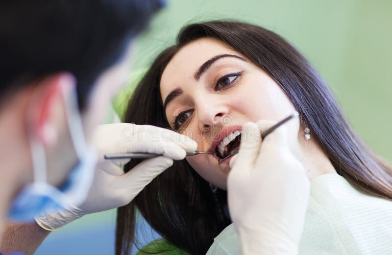 The Patient Caring for Teeth in the Dental Clinic Stock Photo - Image ...
