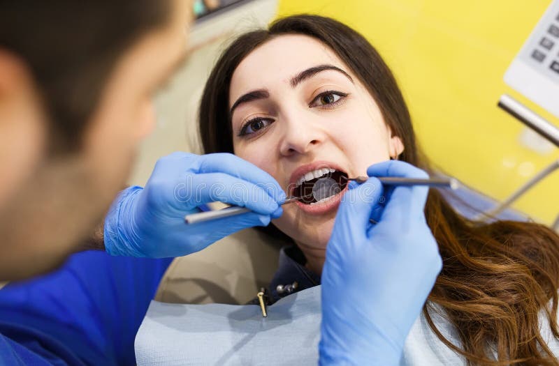The Patient Caring for Teeth in the Dental Clinic Stock Image - Image ...