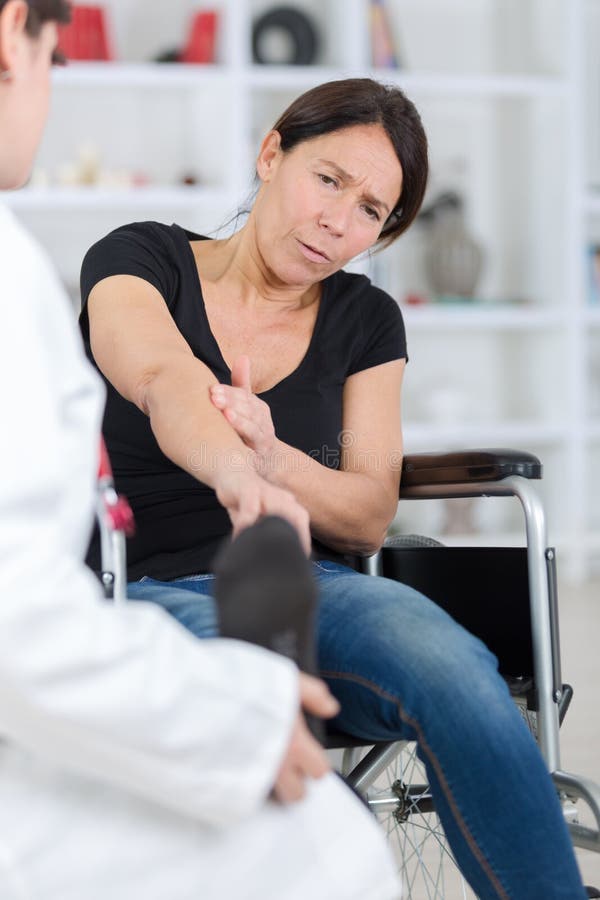 Patient Complaining about Arm in Medical Office Stock Photo - Image of ...