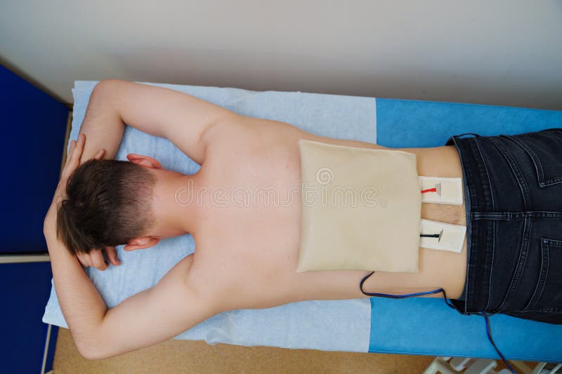 Patient with an Electrotherapy on the Back, Electrical Stimulation ...