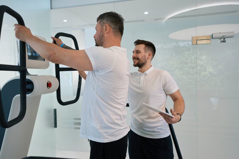 Patient Exercising on Modern Rehabilitation Equipment Stock Photo ...