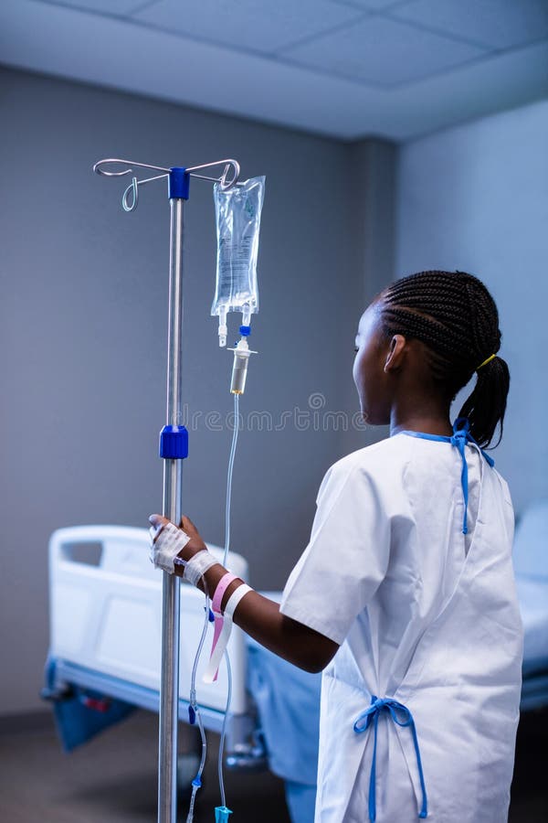 Boy Patient Holding Intravenous Iv Drip Stand in Corridor Stock Photo ...