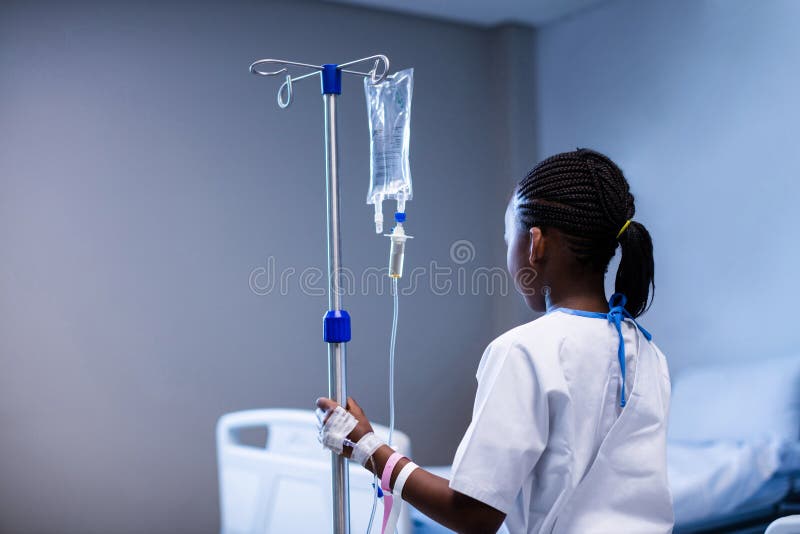 Boy Patient Holding Intravenous Iv Drip Stand in Corridor Stock Photo ...