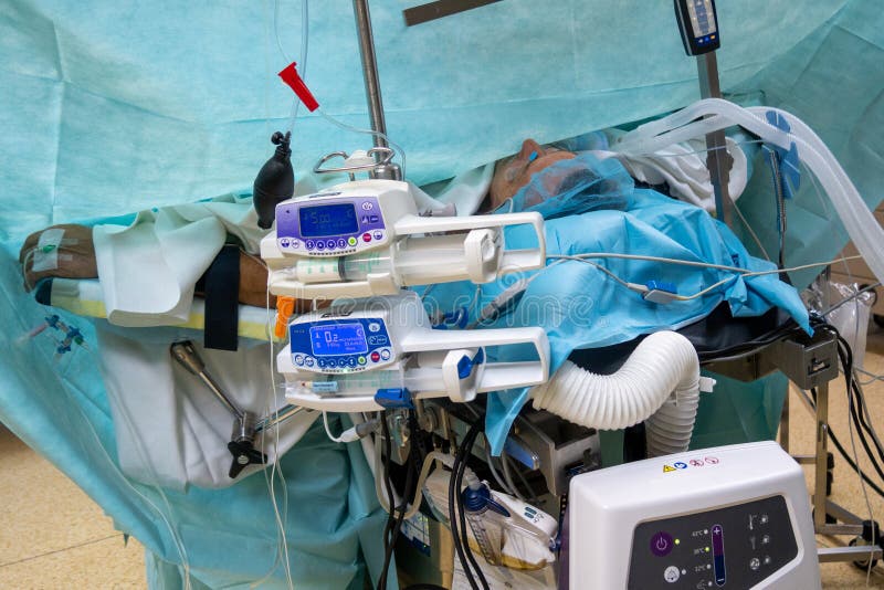 Patient Lies Ventilated Under General Anesthesia on an Operating Table ...