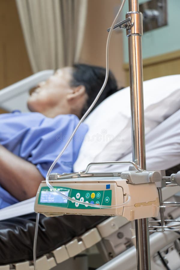 The Patient is Lying on a Bed in a Hospital with an Automatic Infusion ...