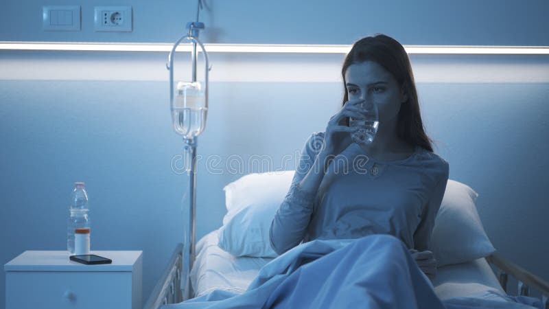 Patient Lying in Bed at the Hospital and Drinking Water Stock Photo ...