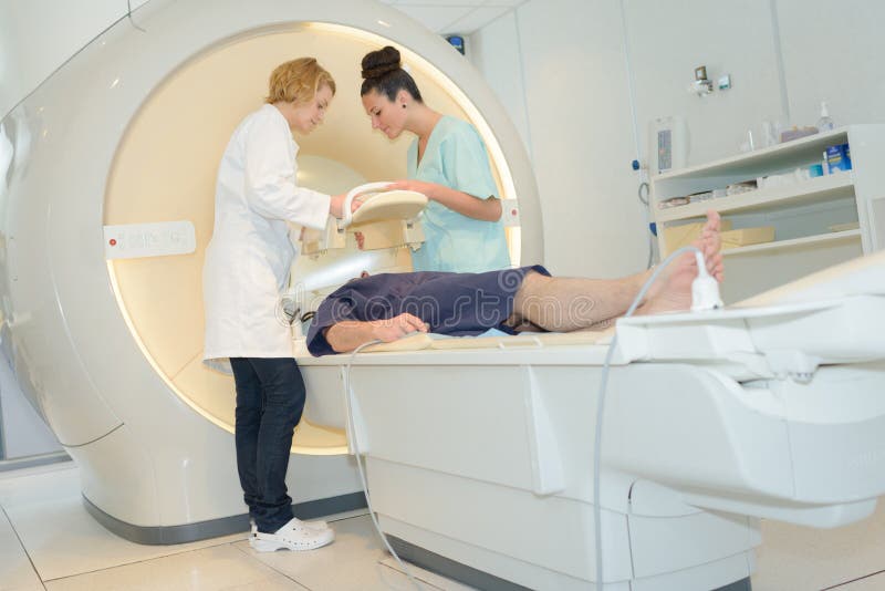 Patient on Mri Machine while Two Female Doctors Operating it Stock ...