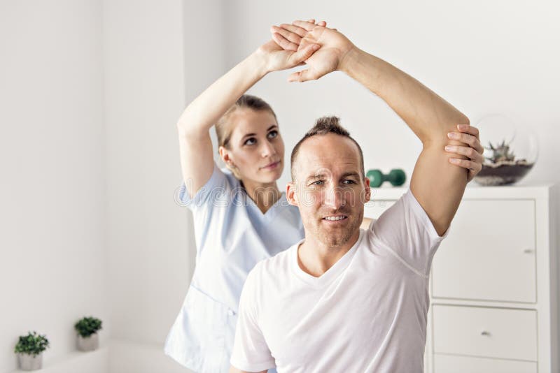 Patient at the Physiotherapy Doing Physical Exercises with His ...