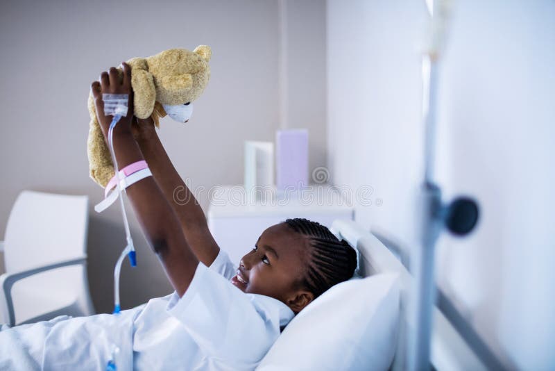 Patient Playing with Teddy while Resting on the Bed Stock Image - Image ...