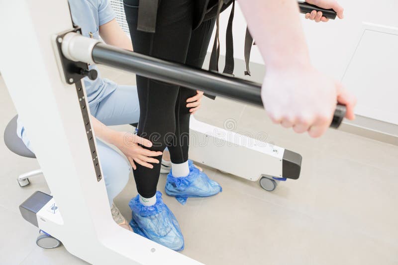 Patient Practicing Supported Standing and Walking with Therapist ...