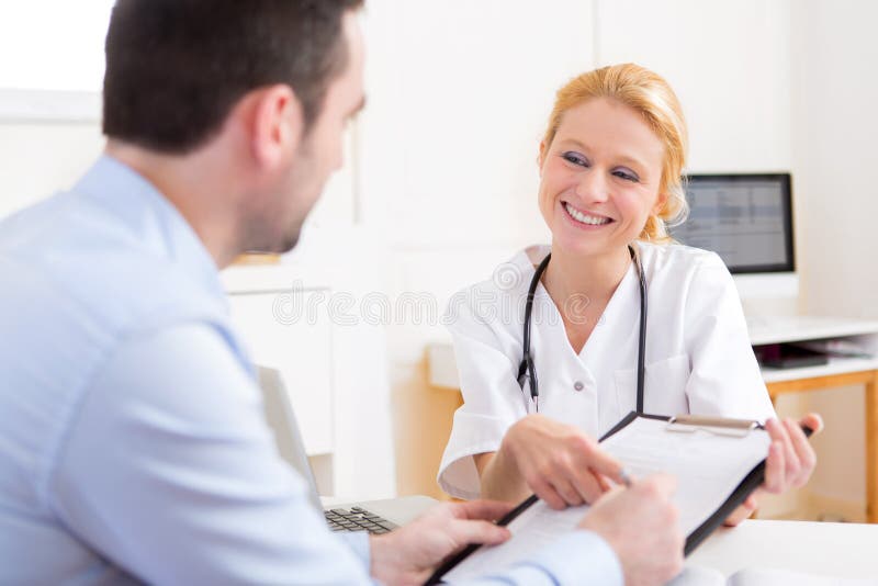 Patient Signing the Document of a Young Attractive Doctor Stock Image ...