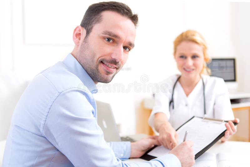 Patient Signing the Document of a Young Attractive Doctor Stock Image ...