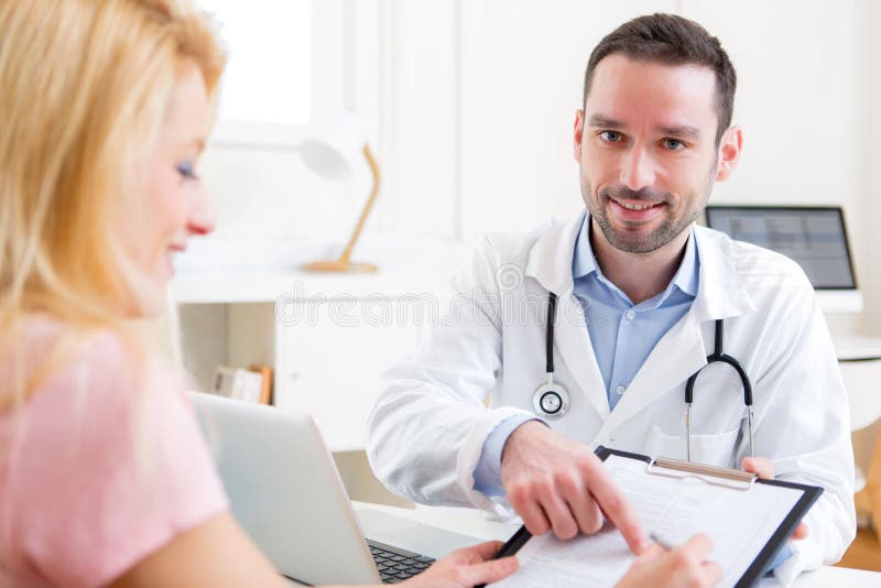 Patient Signing the Document of a Young Attractive Doctor Stock Image ...