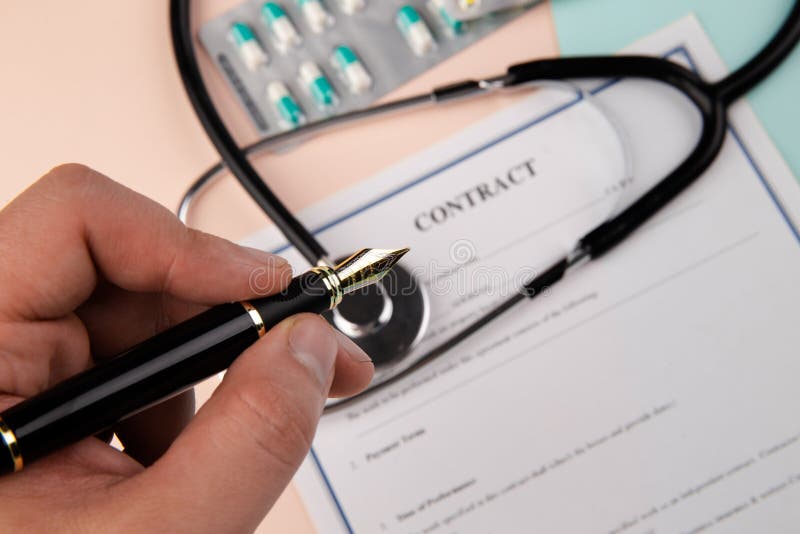 Patient Signs a Document with His Doctor in Medical Office Stock Photo ...