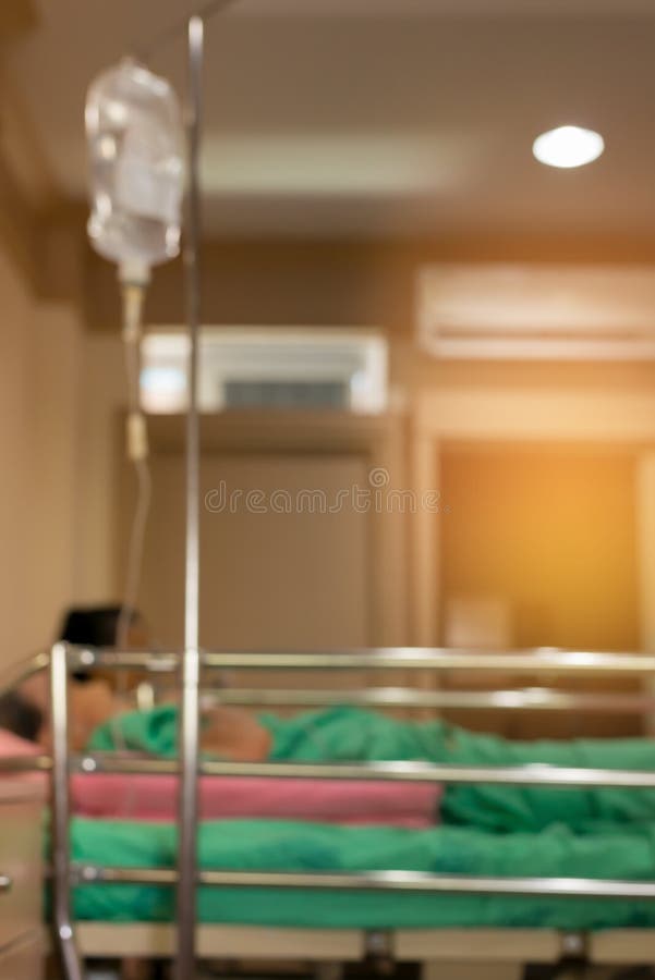 Patient Sleeping in Bed Receiving Drip of Saline Solution,blurred for ...