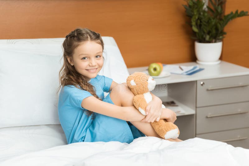 Patient with Teddy Bear Sitting on Bed in Hospital Stock Image - Image ...