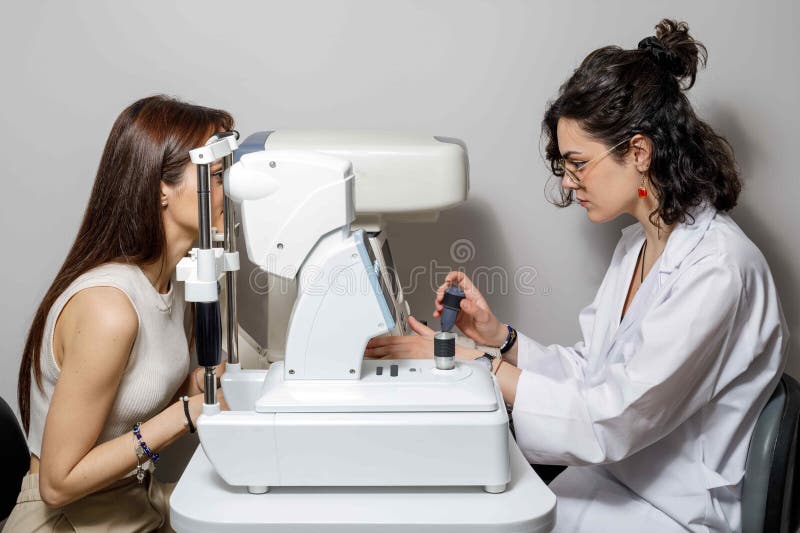Patient Undergoing an Eye Examination with an Ophthalmologist Using a ...
