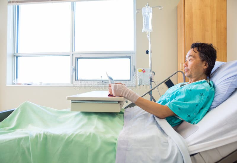 Patient Using Digital Tablet on Hospital Bed Stock Image - Image of ...