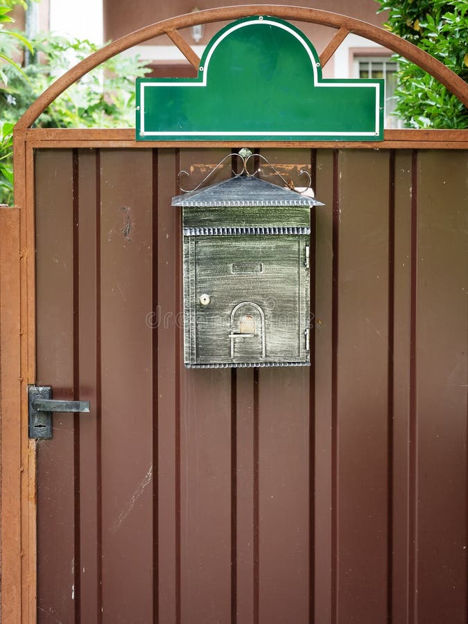 Patina Mailbox Hanging on a Brown Iron Door Stock Photo - Image of ...