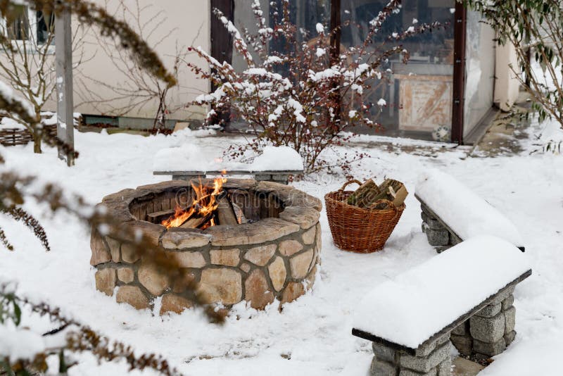 Bonfire Under the Snow. Patio during Snowfall in Winter. Beautiful Yard ...