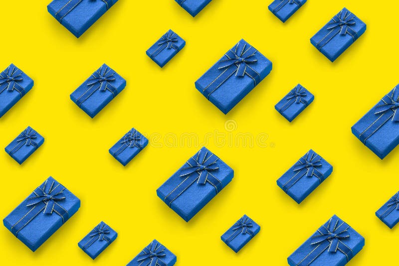 Pattern of Blue Gift Boxes Tied with a Ribbon on a Yellow Background ...