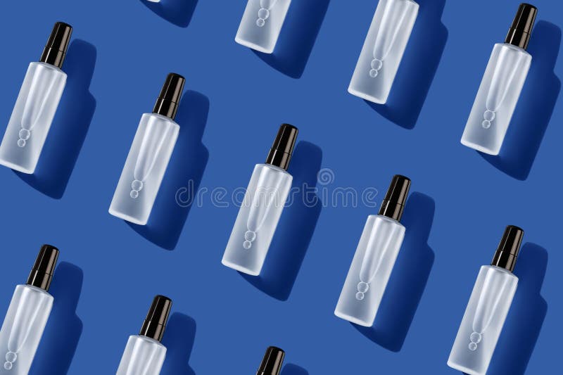 Pattern of Blue Spray Bottle Laying on a Blue Background with a Long ...