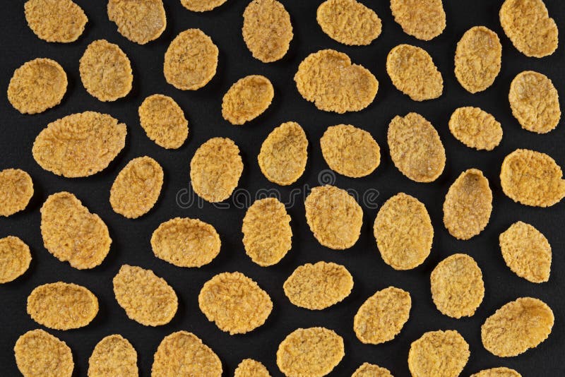 Pattern of Corn Flakes on Black Background, Top View Stock Photo ...