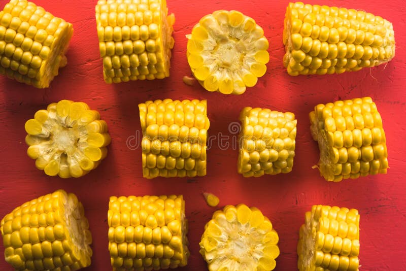 Pattern from Different Pieces of Corn on a Pink Table Stock Photo ...